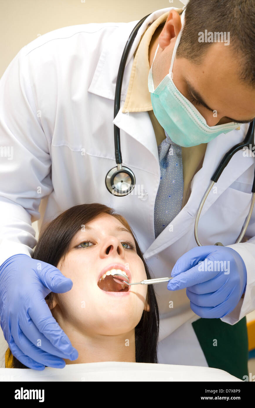 the dentist is looking at the patient's teeth Stock Photo - Alamy