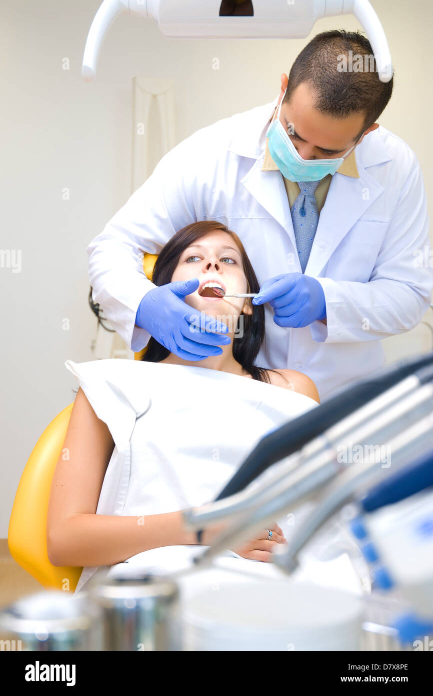 the dentist is looking at the patient's teeth Stock Photo - Alamy
