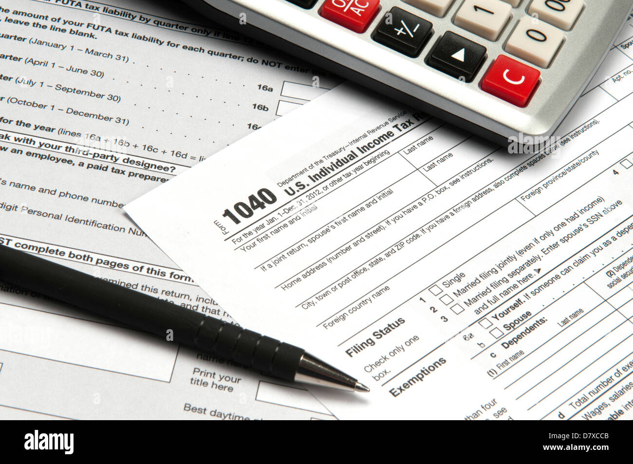 View of desk with financial and tax papers, calculator and pen Stock ...