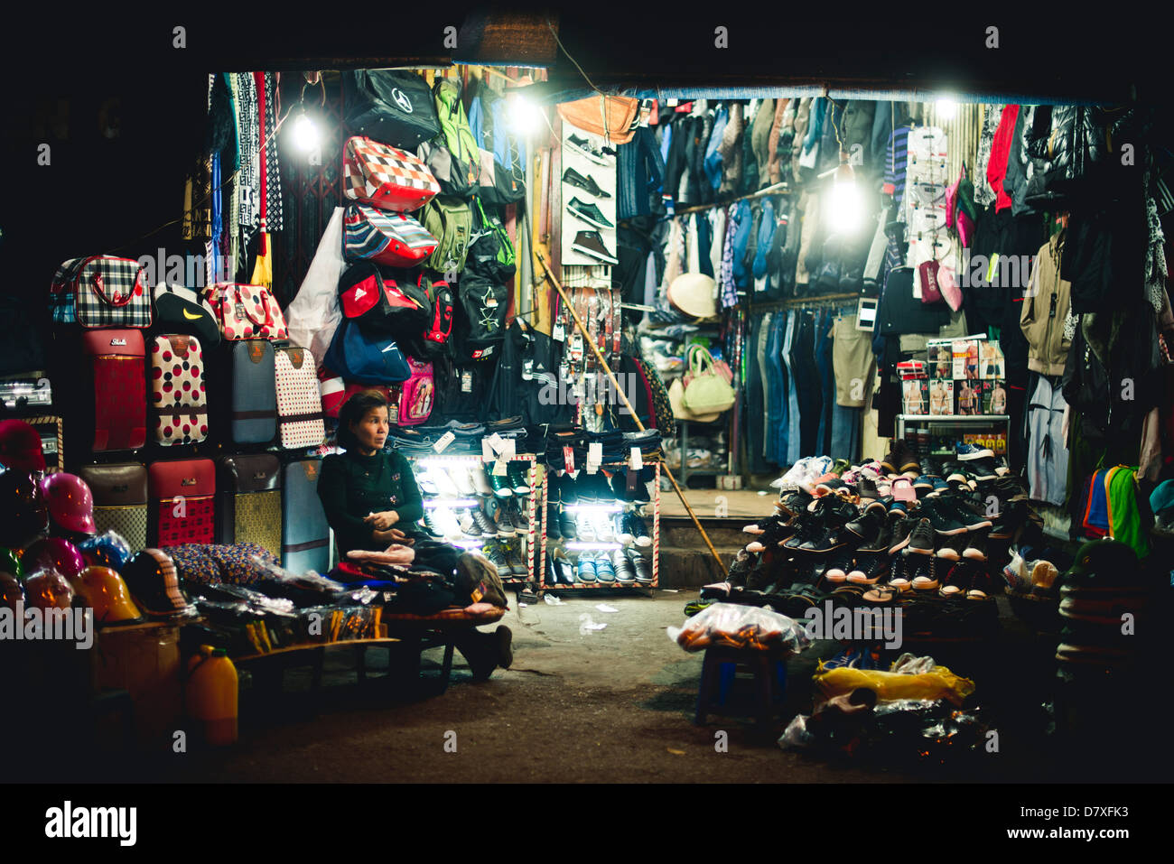 A shop owner minding her store at night Stock Photo - Alamy