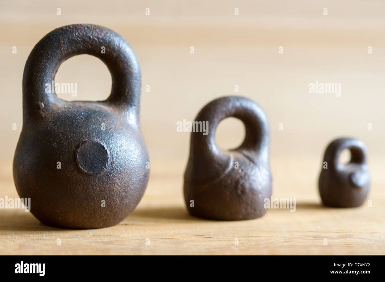 Three small calibration weights standing on wooden background Stock ...
