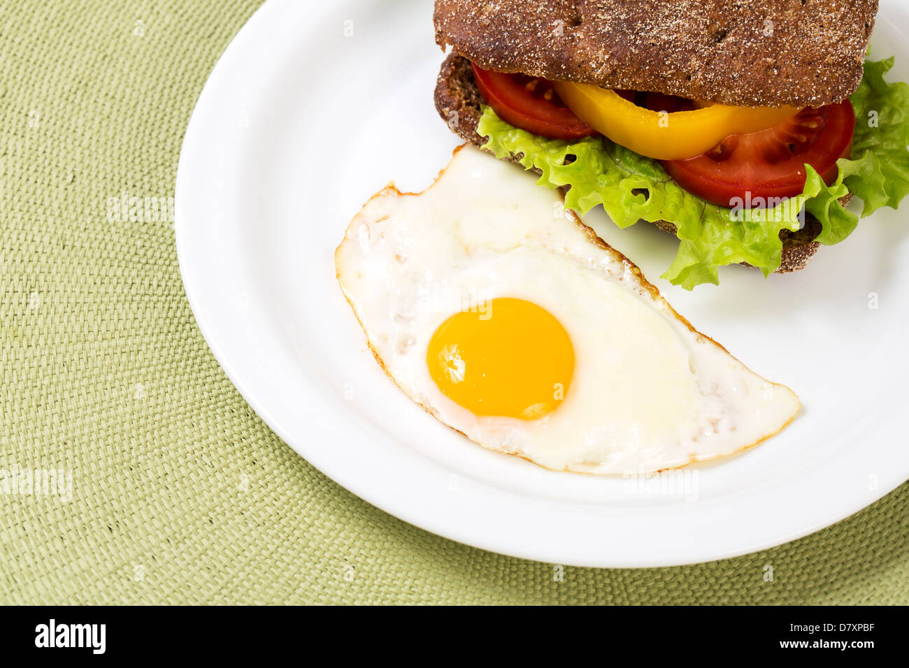 Breakfast sandwich with vegetables with baked hen egg Stock Photo - Alamy