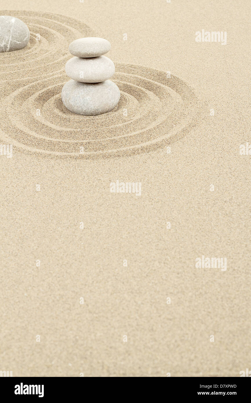 Balance of three zen stones in sand Stock Photo - Alamy