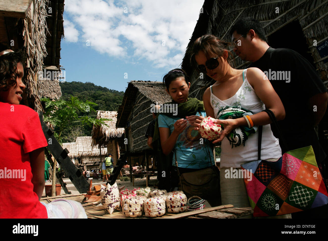 Tourists purchase souvenirs from the Moken sea nomads Stock Photo - Alamy