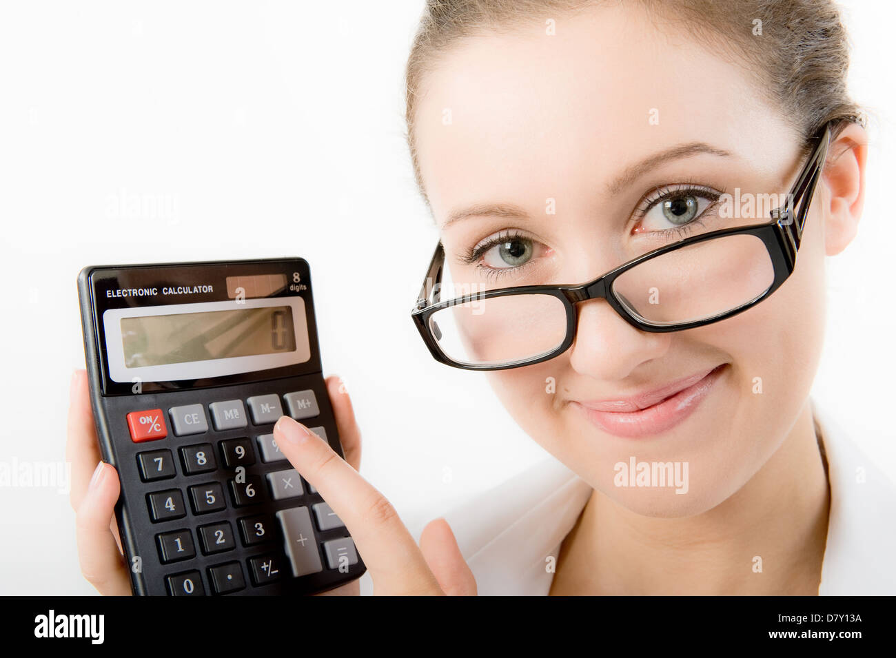 Smiling young woman holding a calculator and wearing glasses Stock ...
