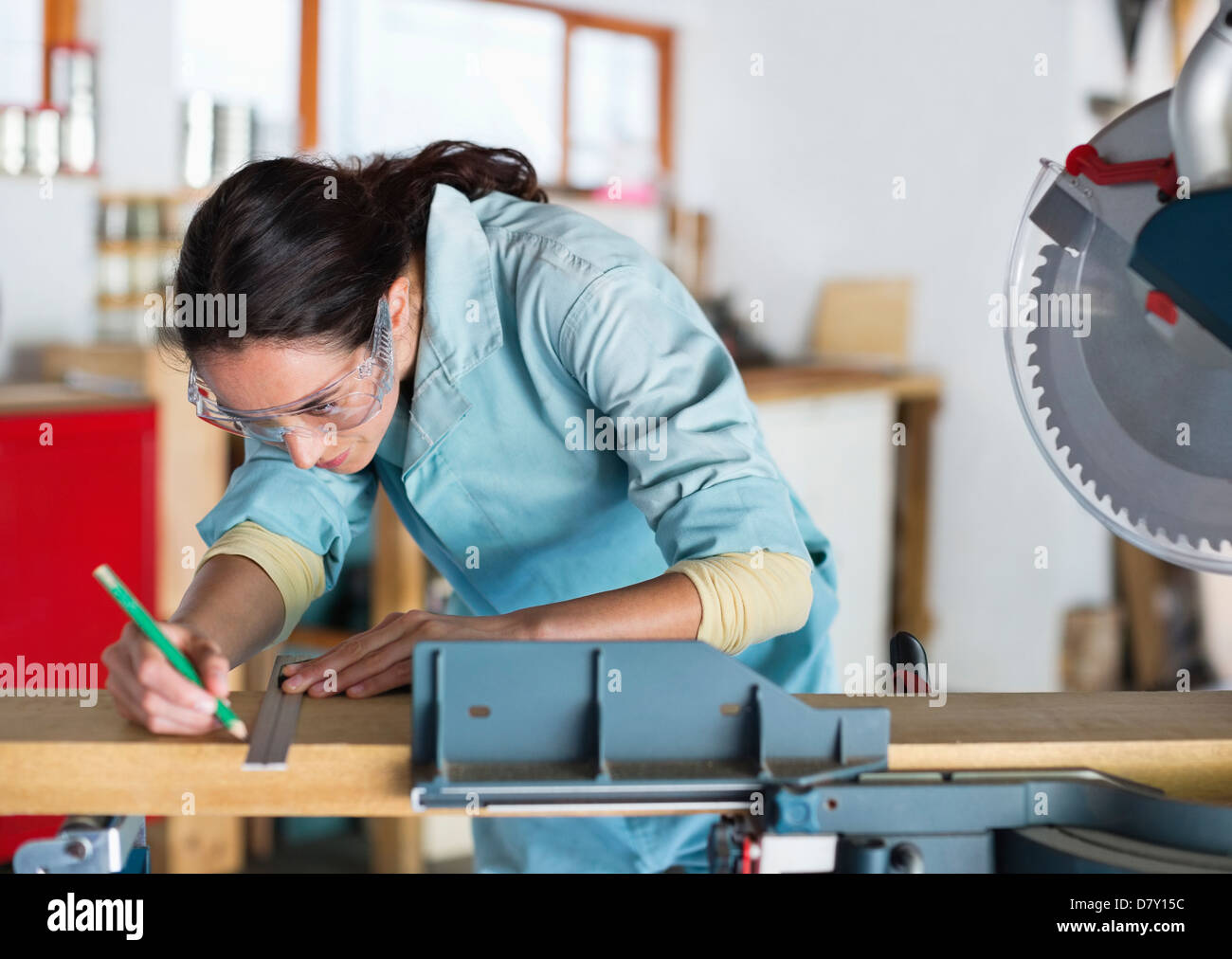 Woman working in workshop Stock Photo - Alamy
