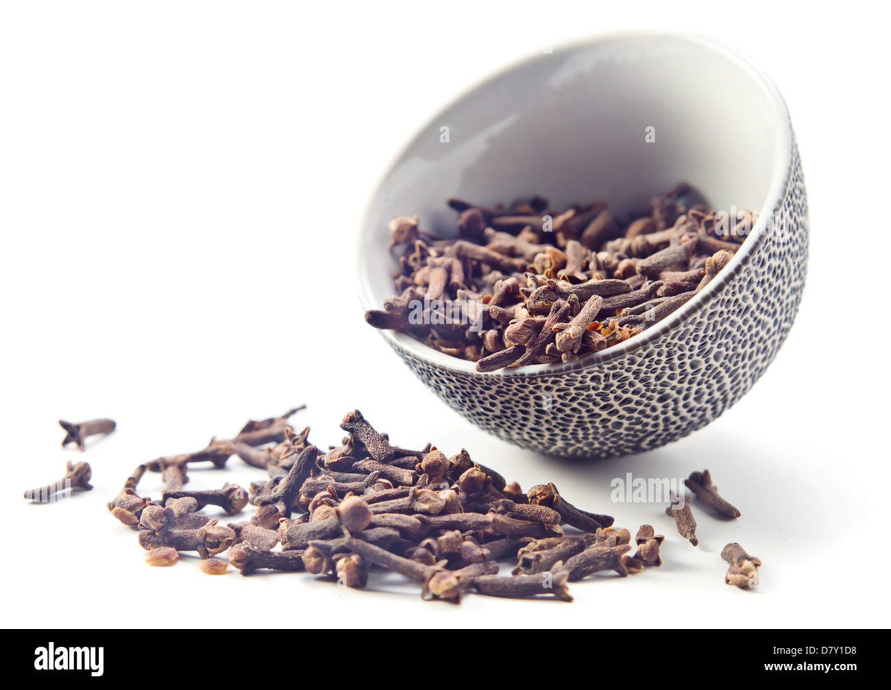 cloves in a small ceramic cup on a white background Stock Photo - Alamy