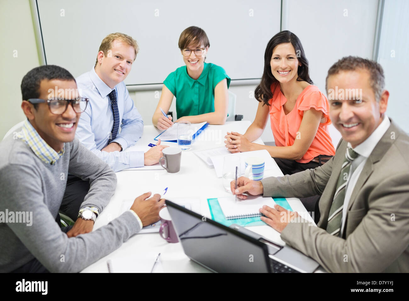 Business people smiling in meeting Stock Photo - Alamy