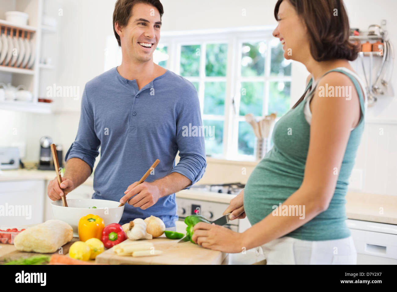 Couple cooking together in kitchen Stock Photo - Alamy
