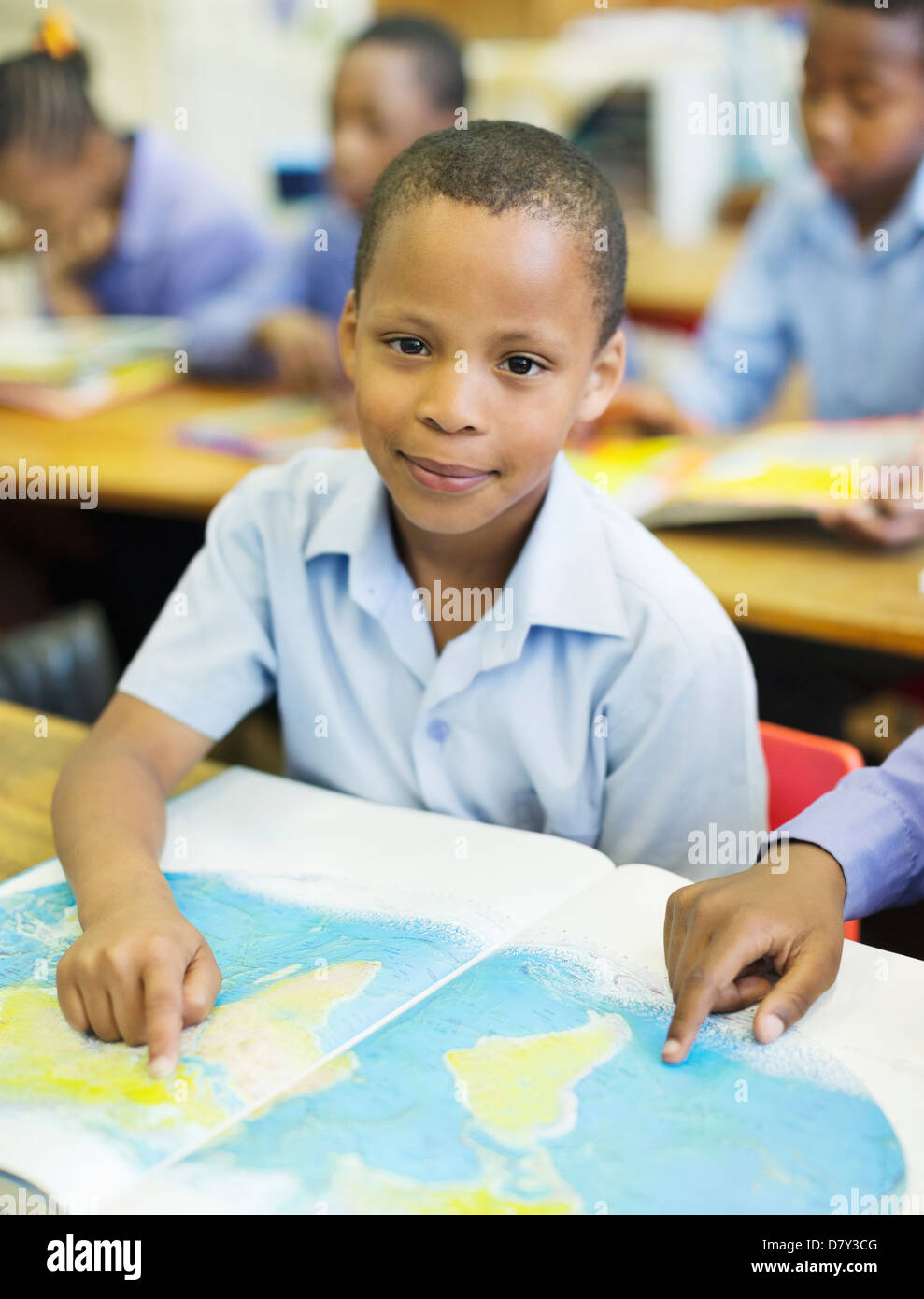 Students using world map in class Stock Photo - Alamy