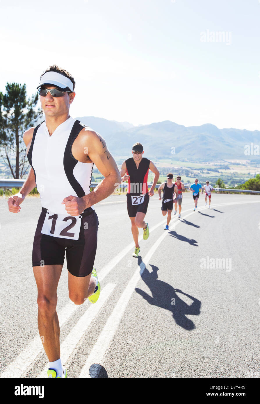 Runners in race on rural road Stock Photo - Alamy