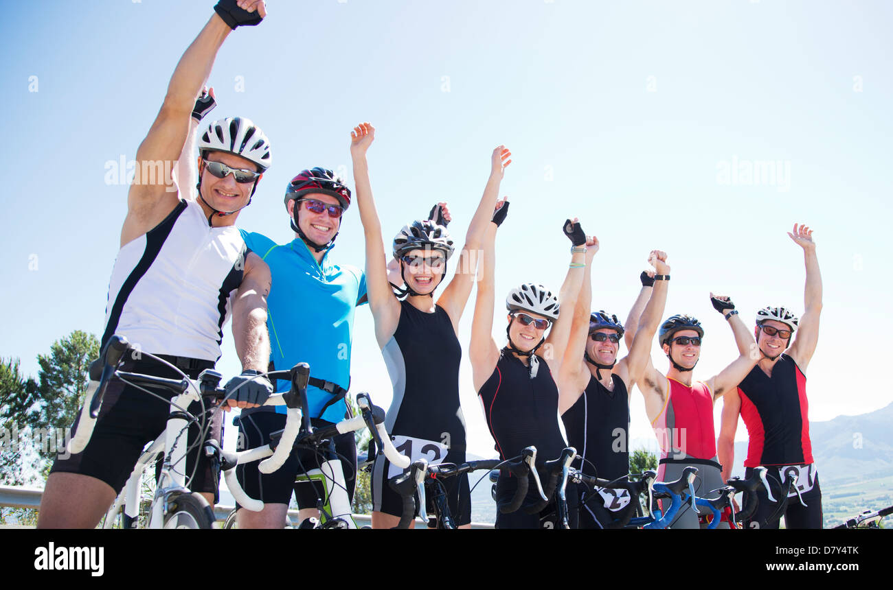 Cyclists cheering together outdoors Stock Photo - Alamy