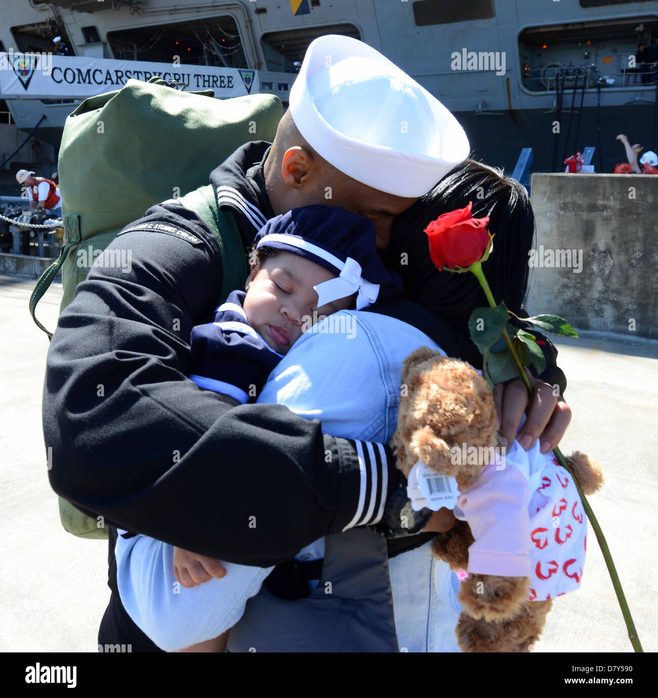 A sailor hugs his family Stock Photo - Alamy