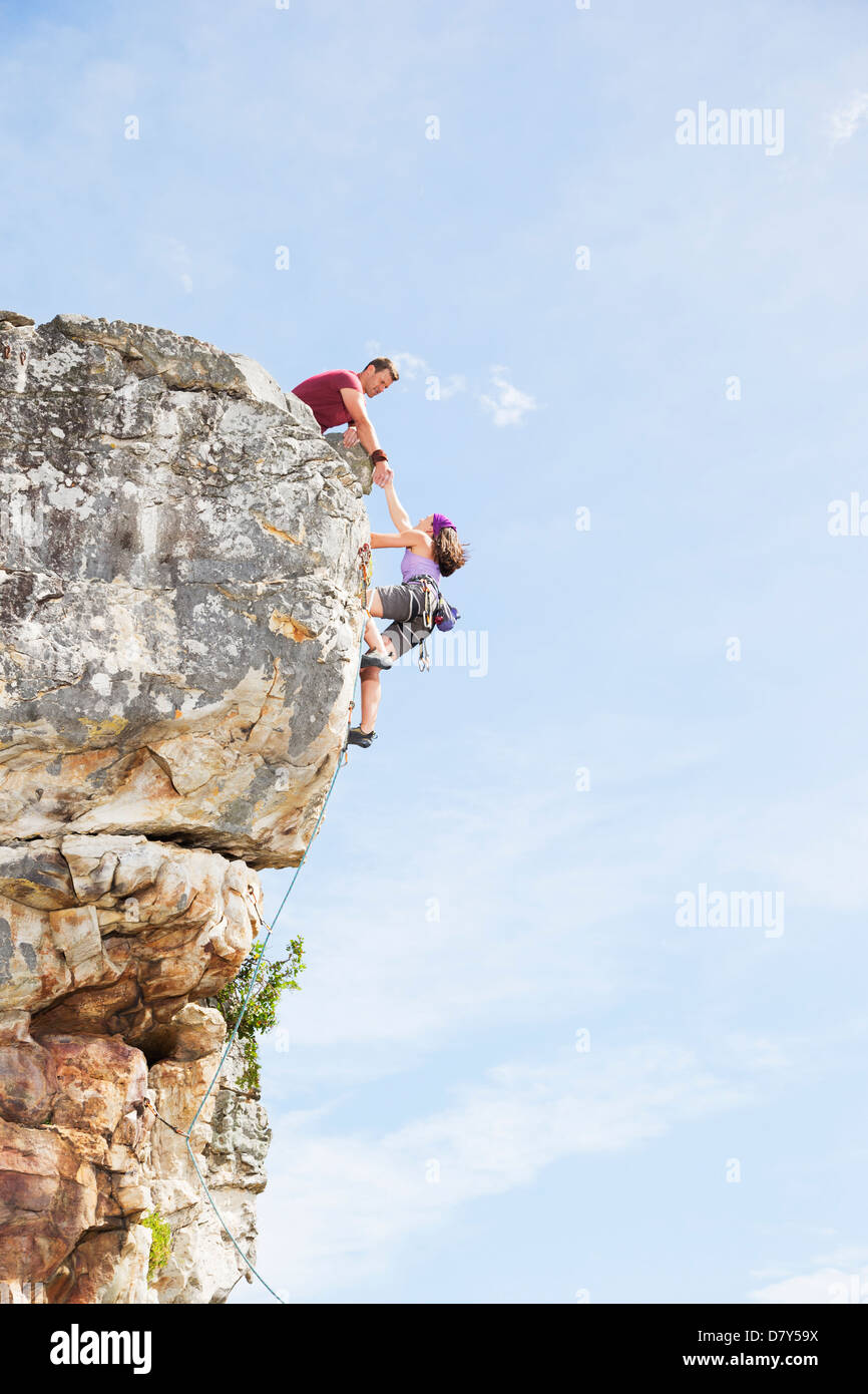 Climbers scaling steep rock face Stock Photo - Alamy