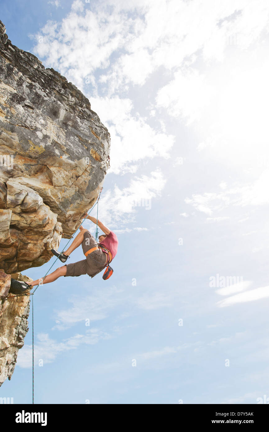 Climber scaling steep rock face Stock Photo - Alamy