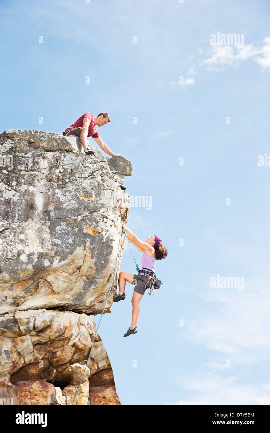Climbers scaling steep rock face Stock Photo - Alamy