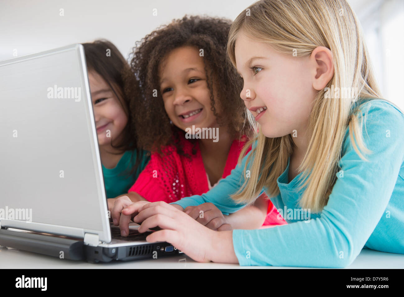 Girls using laptop together Stock Photo - Alamy
