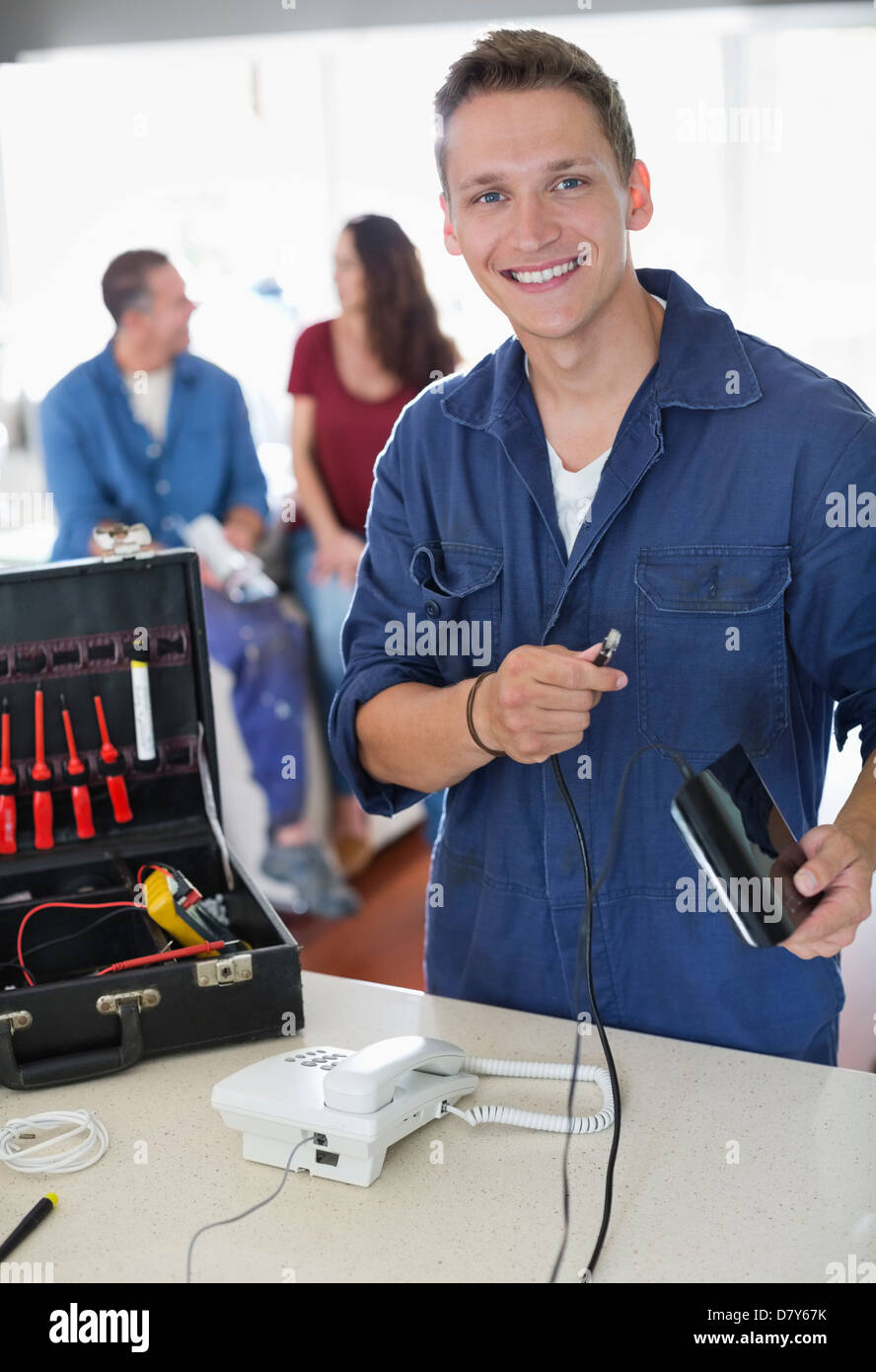 Electrician working on telephone in home Stock Photo - Alamy