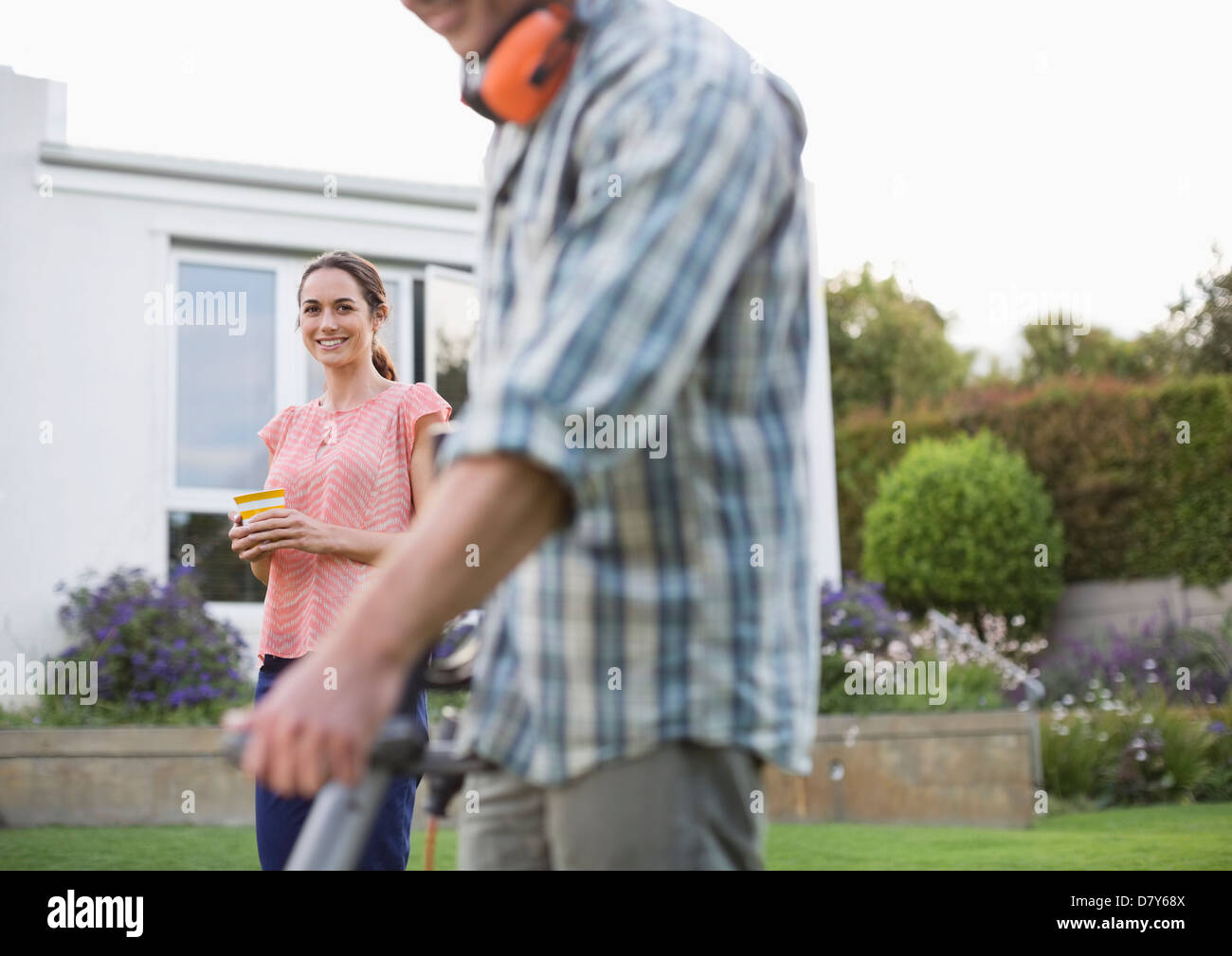 Woman watching man work in garden hi-res stock photography and images ...