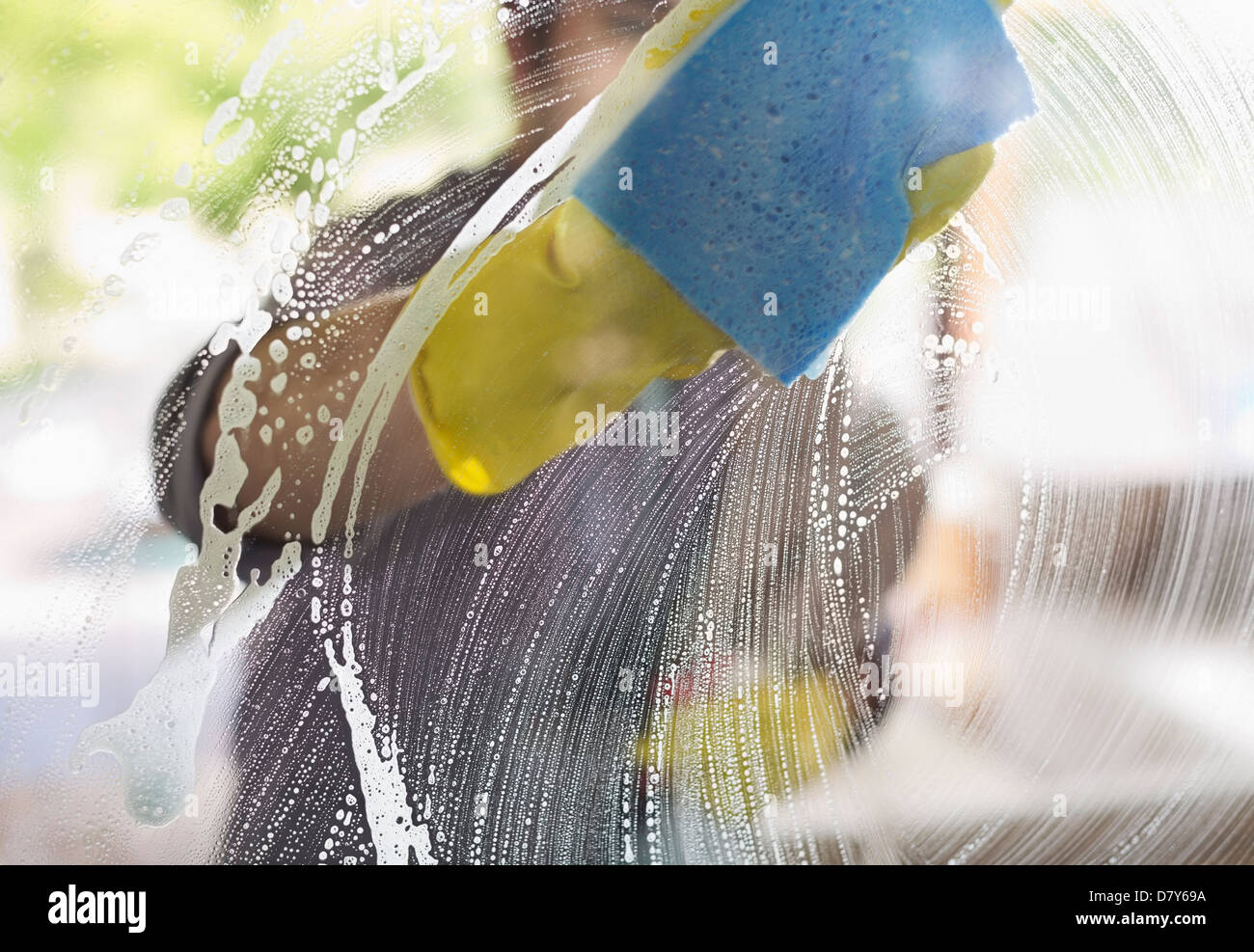 Man washing window with sponge Stock Photo - Alamy