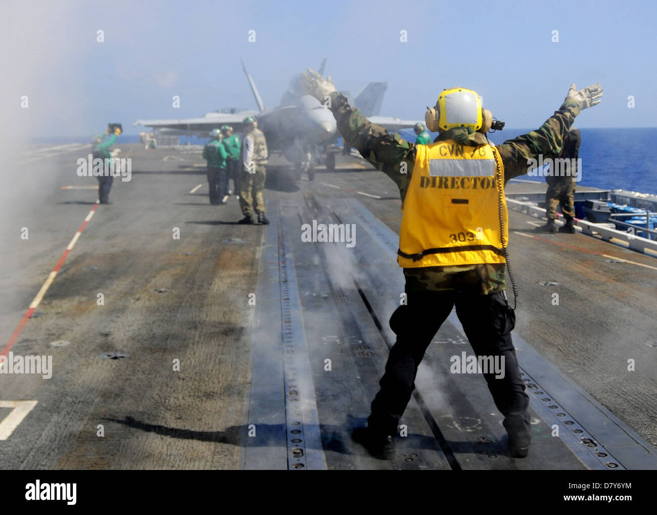 Sailor directs Super Hornet aboard USS Ronald Reagan Stock Photo - Alamy