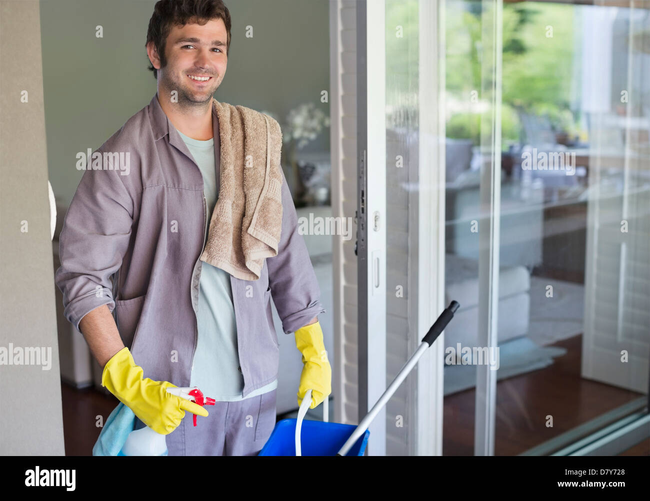 Man carrying bucket of cleaning supplies Stock Photo - Alamy