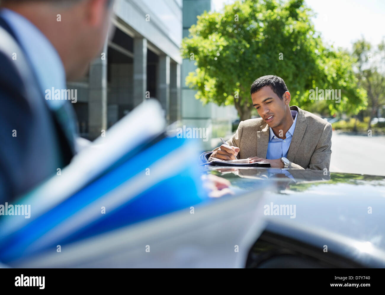 Business people talking at car Stock Photo - Alamy