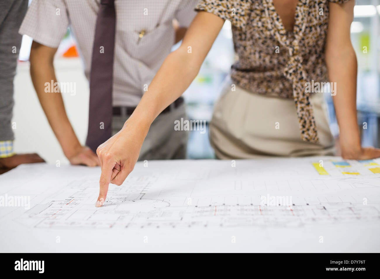 Business people reading blueprints in meeting Stock Photo - Alamy