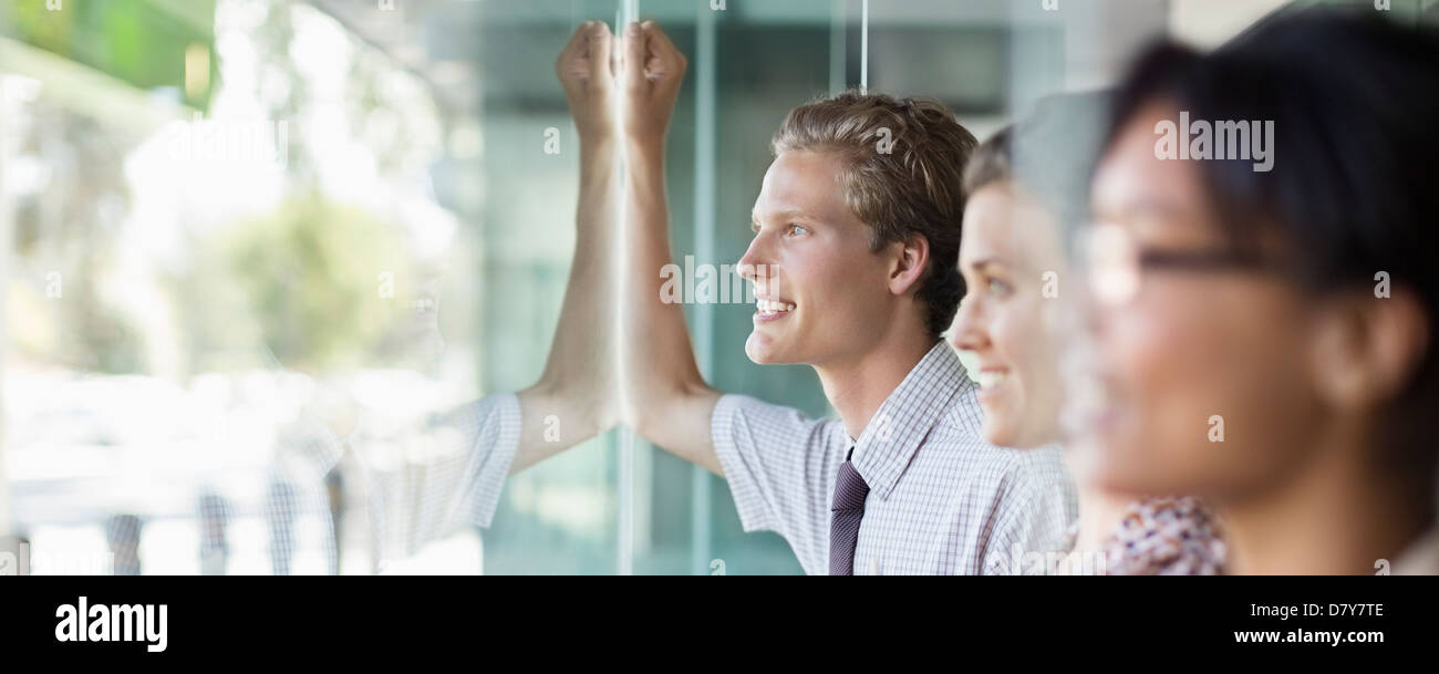 Business people looking out office window Stock Photo - Alamy