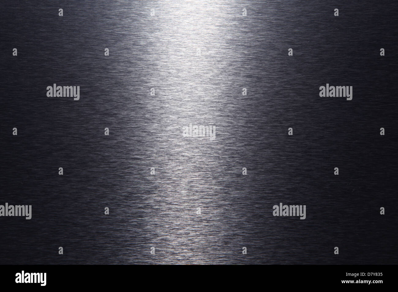 A close-up view of a brushed stainless steel surface with dramatic ...