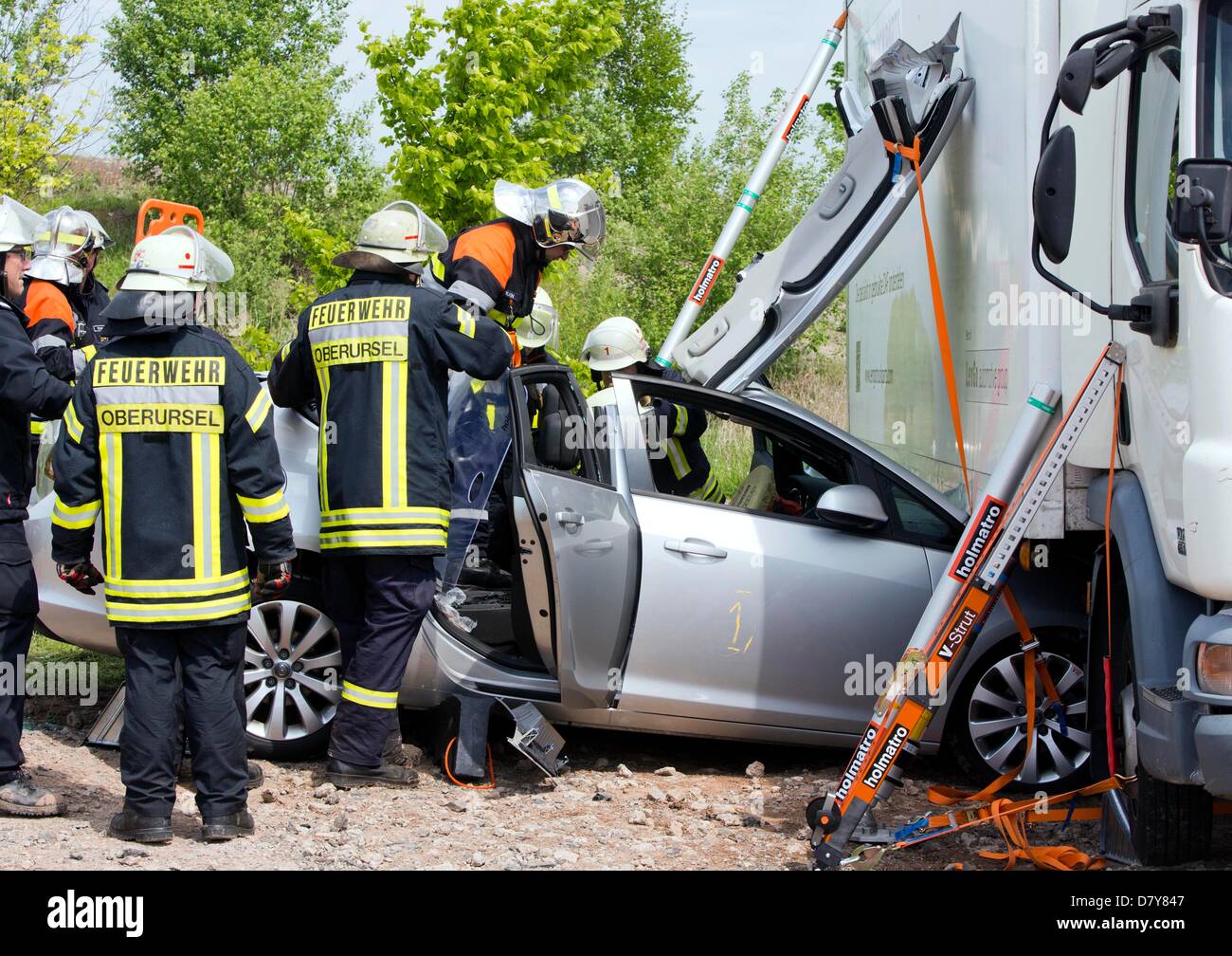Fire fighters from Oberursel and Luxemburg do works on a car that is ...