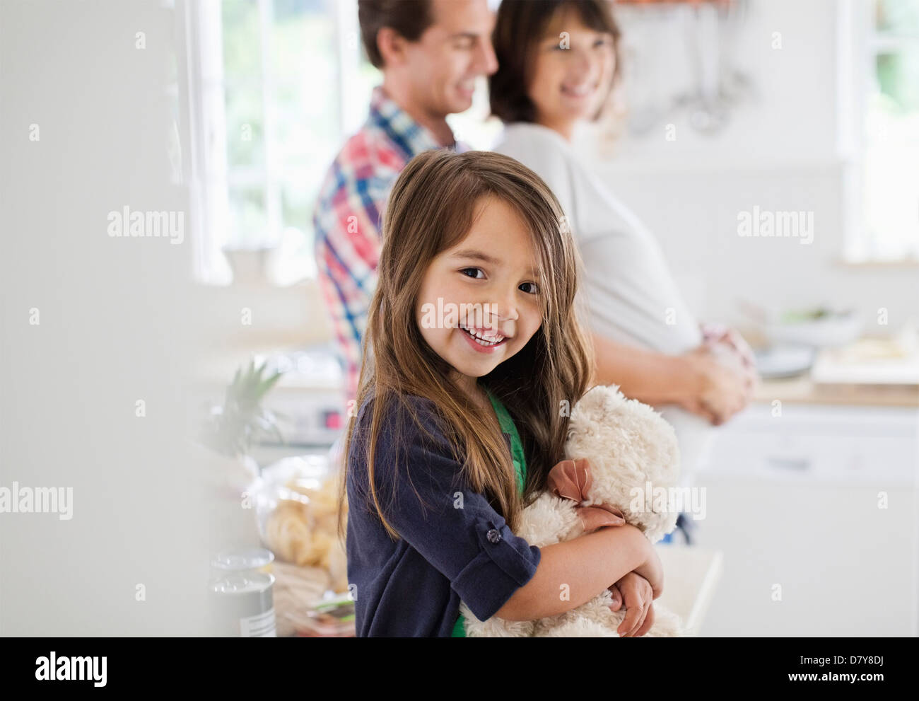 Girl holding teddy bear in kitchen Stock Photo - Alamy