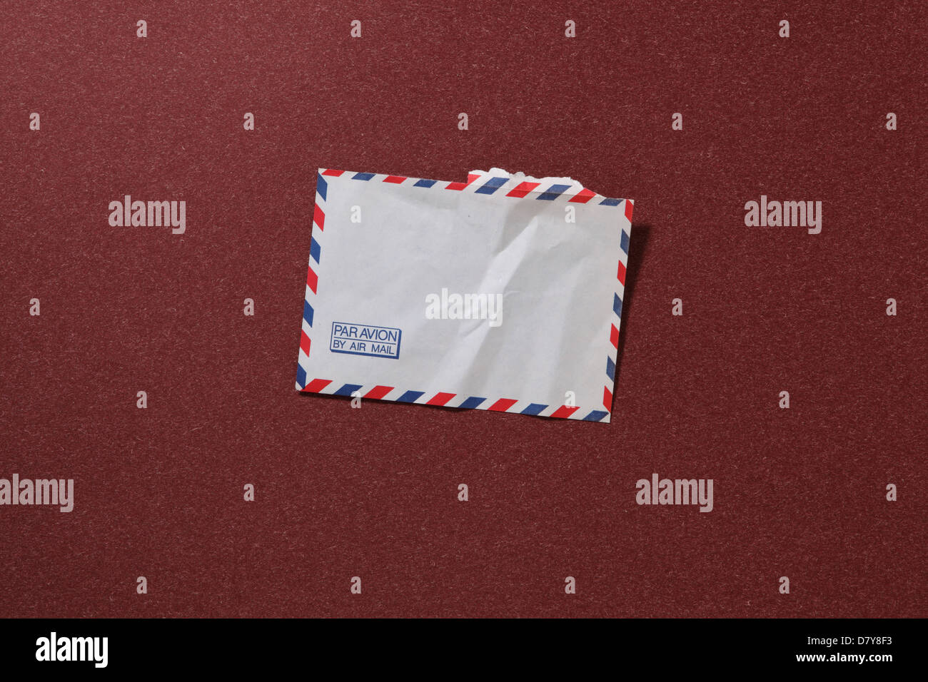 An air mail envelope slightly worn and torn Stock Photo - Alamy