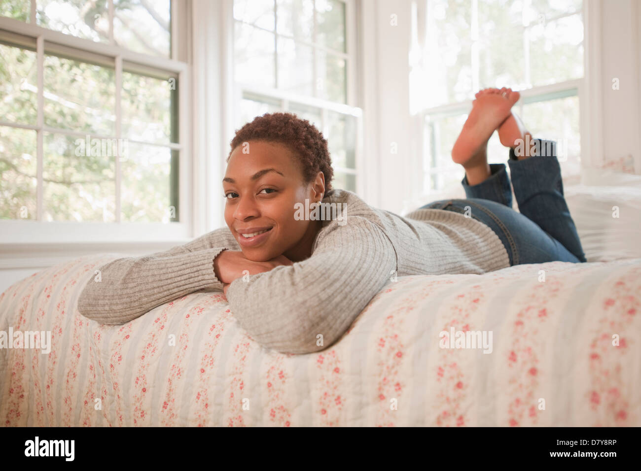 African American woman laying in bed Stock Photo - Alamy