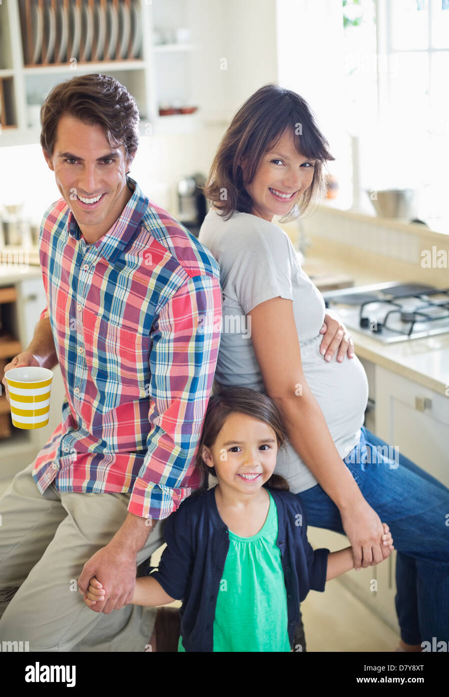 Family smiling together in kitchen Stock Photo - Alamy