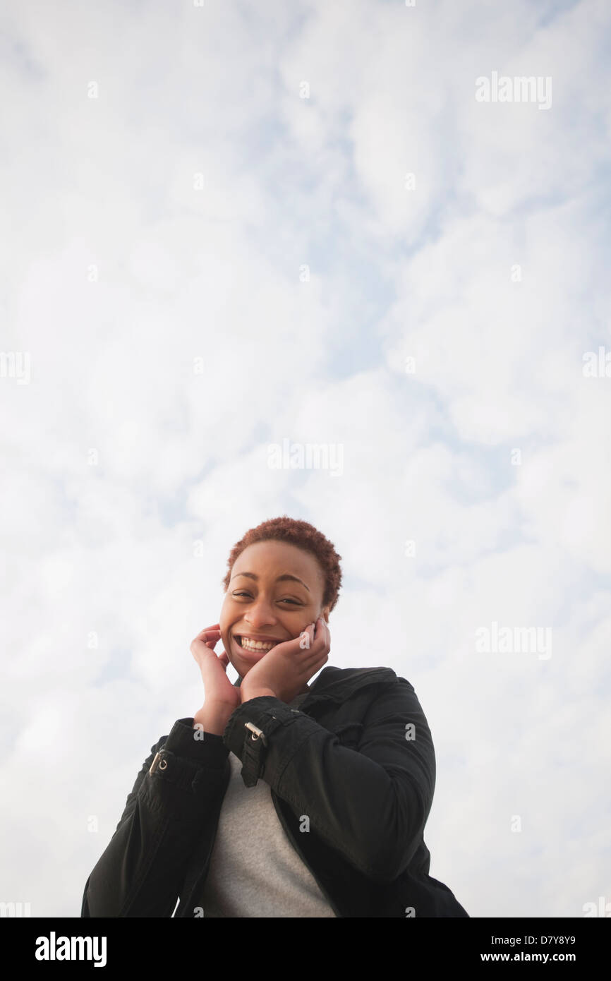 Grinning African American woman standing outdoors Stock Photo - Alamy