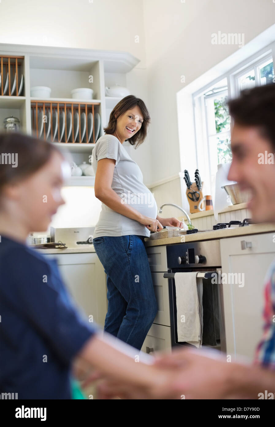 Pregnant mother cooking in kitchen Stock Photo - Alamy
