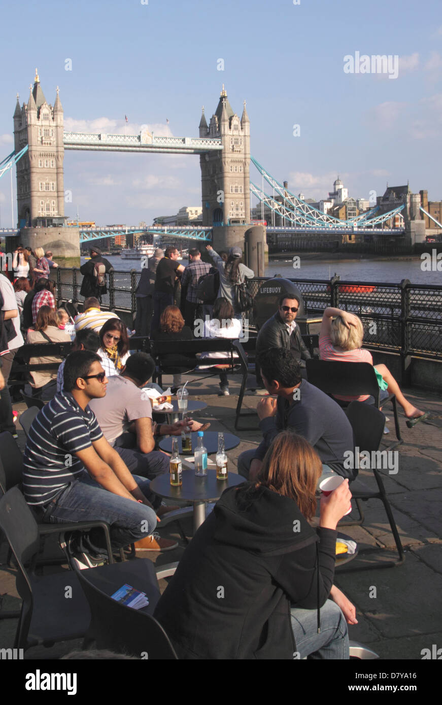 People drinking by the Tower Millennium Pier and Tower Bridge London ...