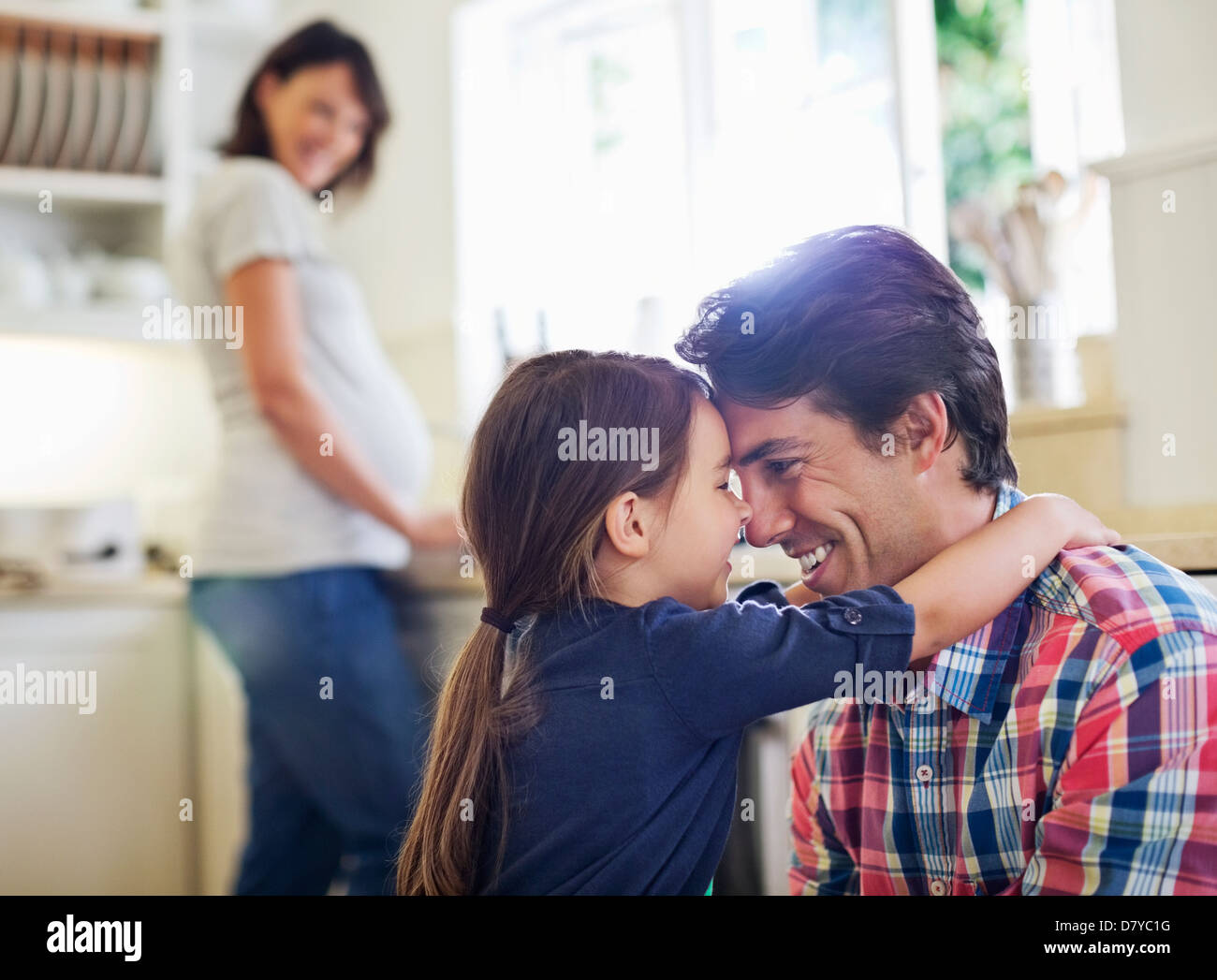 Kneeling woman hugging daughter hi-res stock photography and images - Alamy