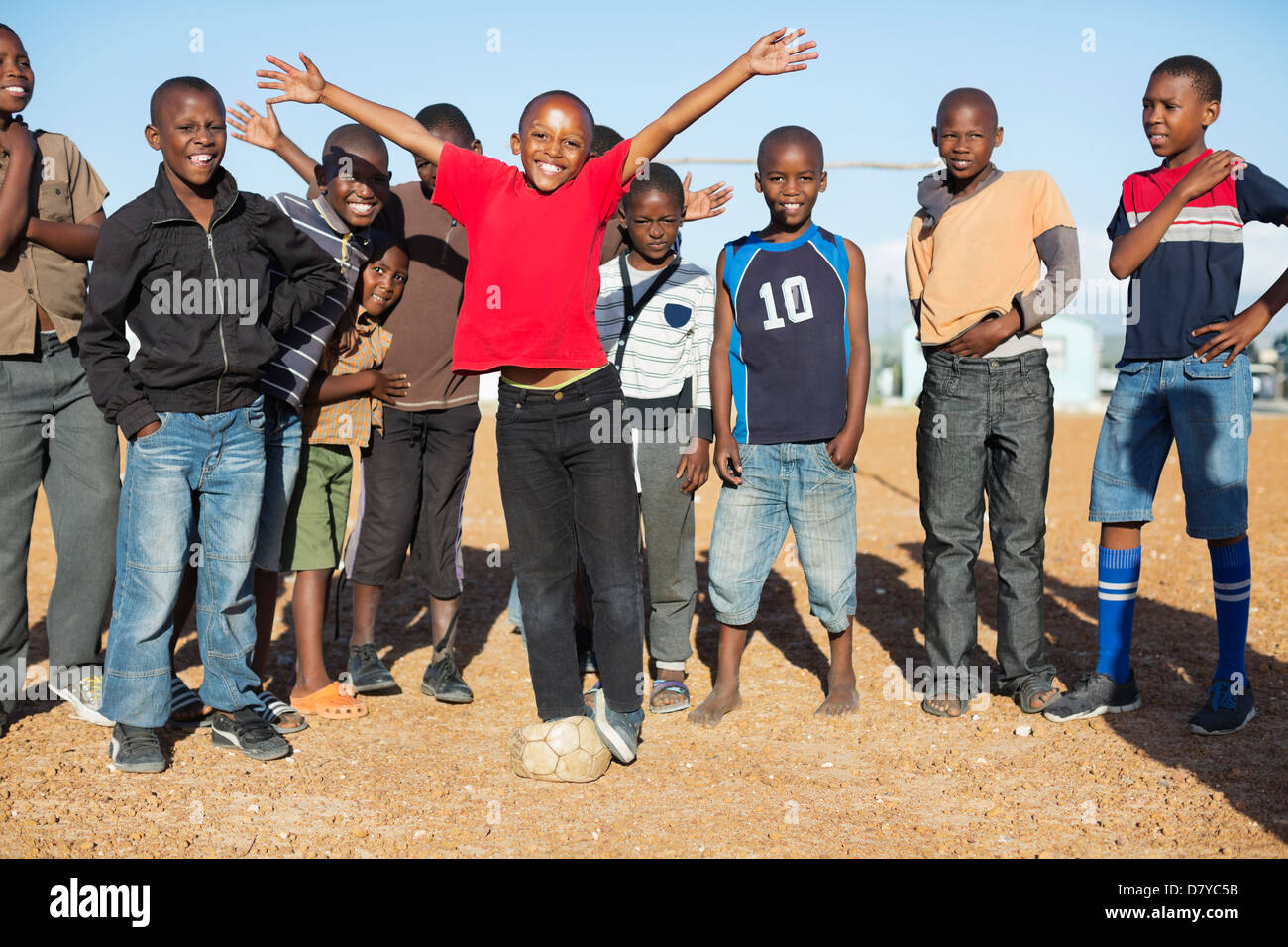 Boys cheering together in dirt field Stock Photo - Alamy