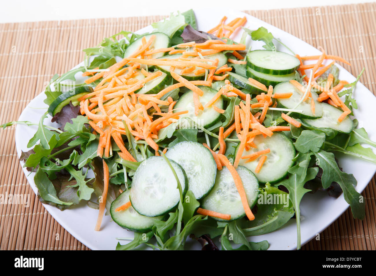 A fresh vegetable salad of arugula, field greens, cucumbers, and ...