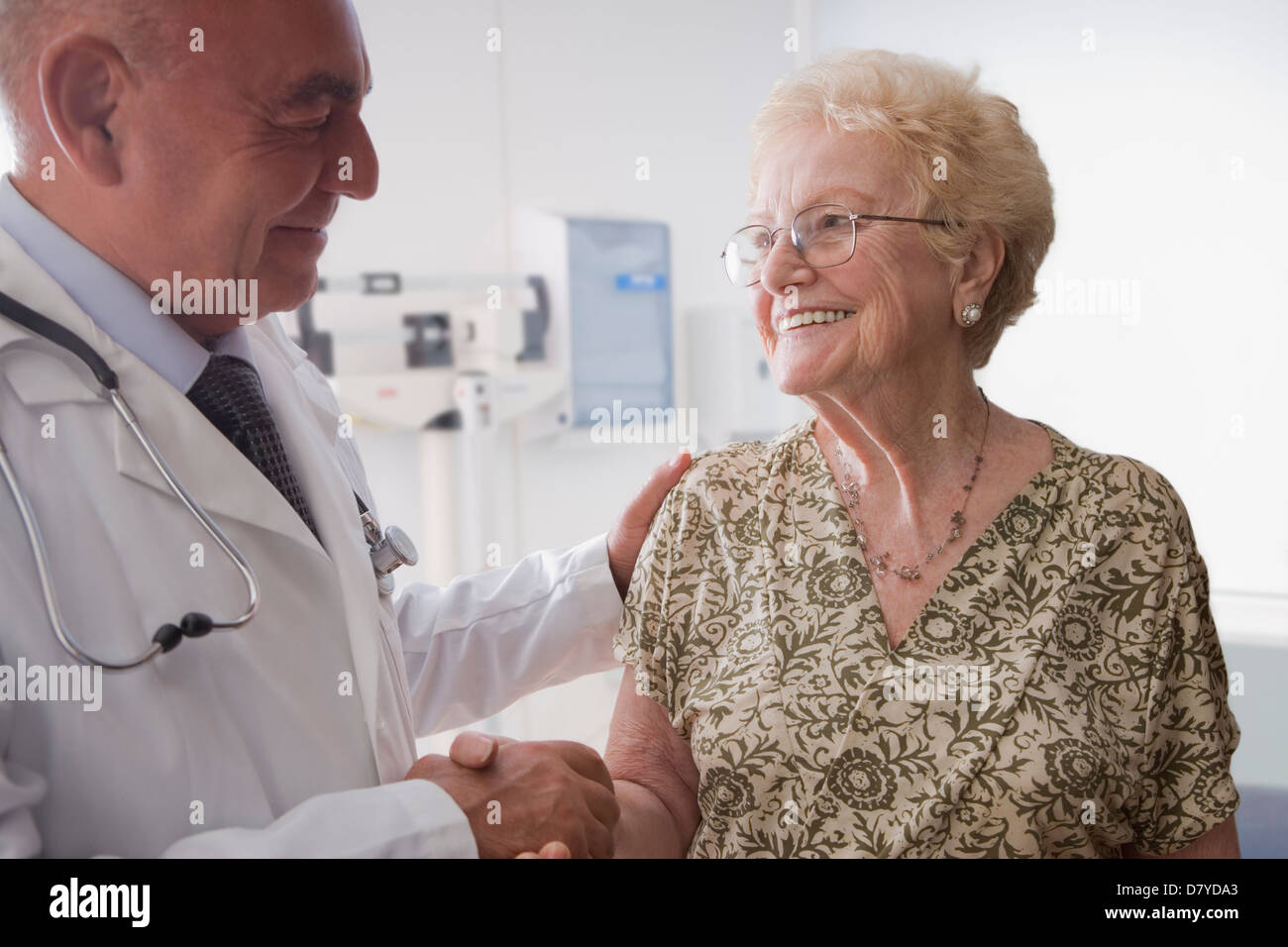 Hispanic doctor talking with older patient Stock Photo - Alamy