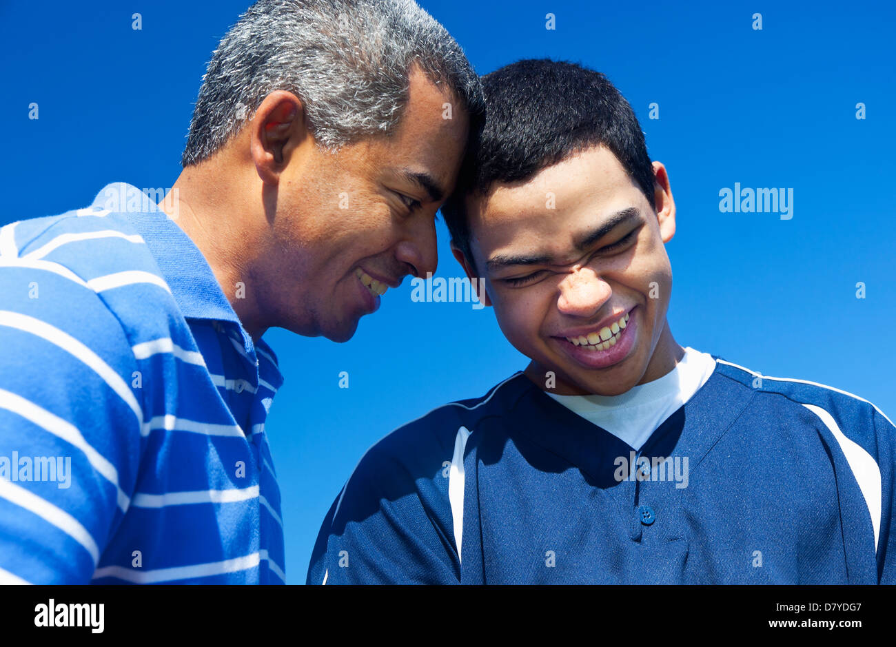 Hispanic father and son playing in park Stock Photo - Alamy