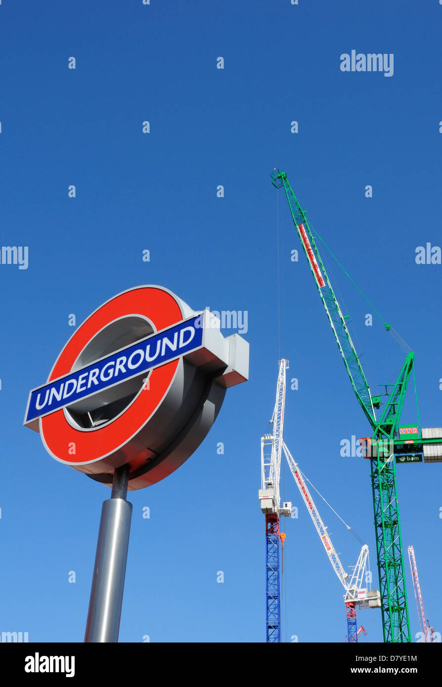 Underground sign and cranes at the King's Cross redevelopment, London ...