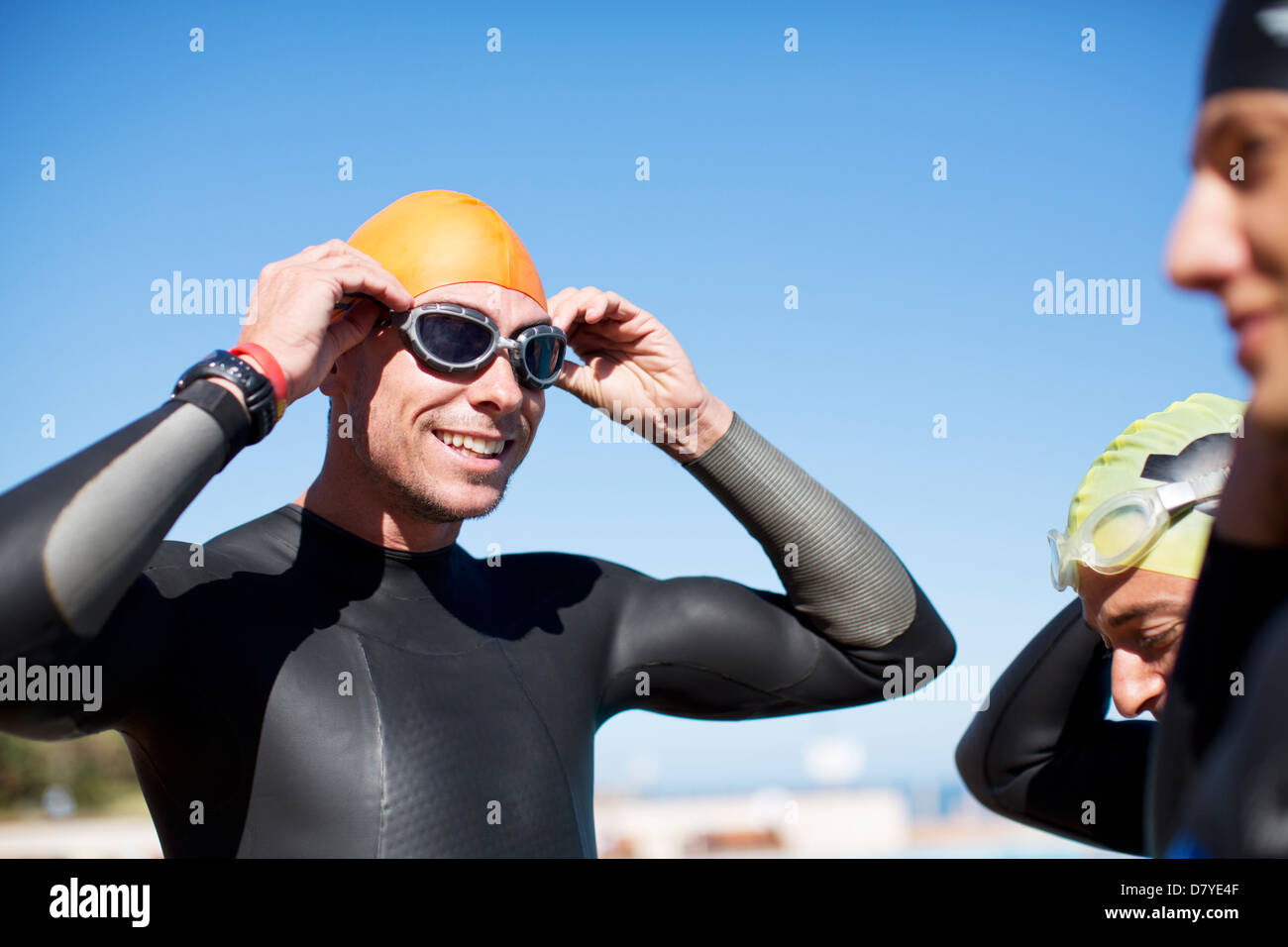 Triathlete adjusting goggles outdoors Stock Photo - Alamy