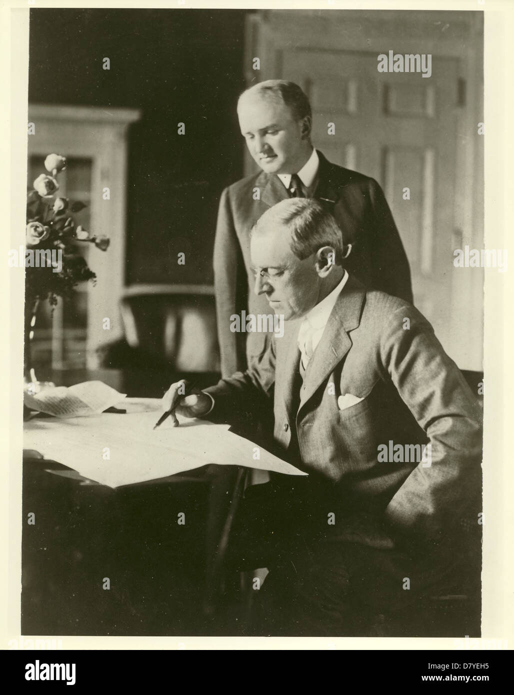 This image shows President Woodrow Wilson writing at his desk with ...