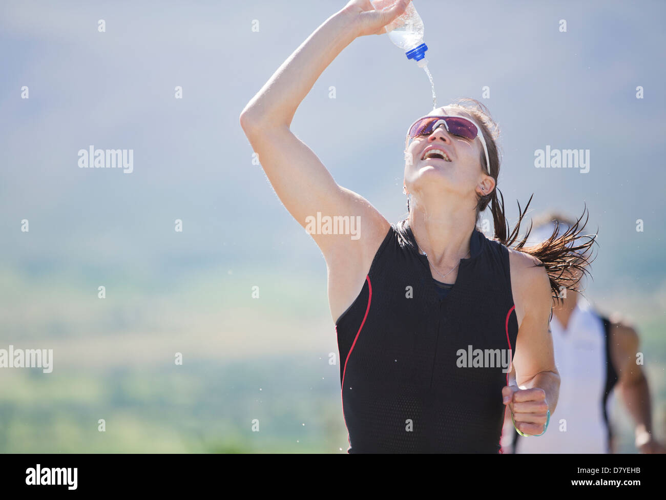 Runner spraying water in race Stock Photo - Alamy