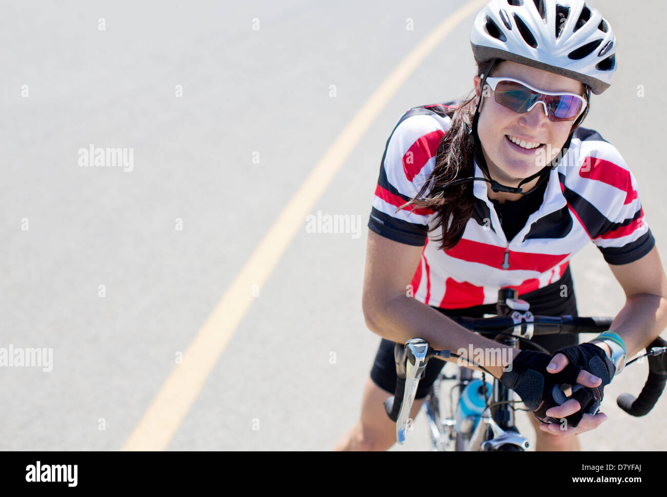 Cyclist smiling on rural road Stock Photo - Alamy