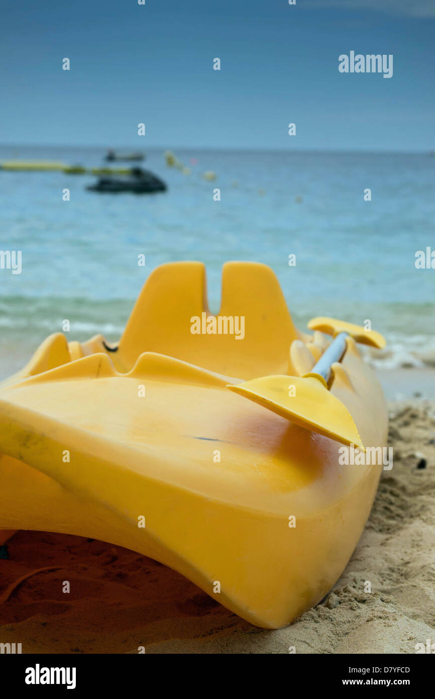 Shot of an yellow kayak standing on the beach Stock Photo - Alamy