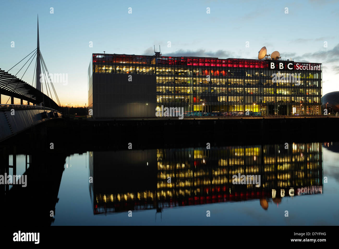 Illuminated BBC Scotland Headquarters on Pacific Quay reflected in the ...